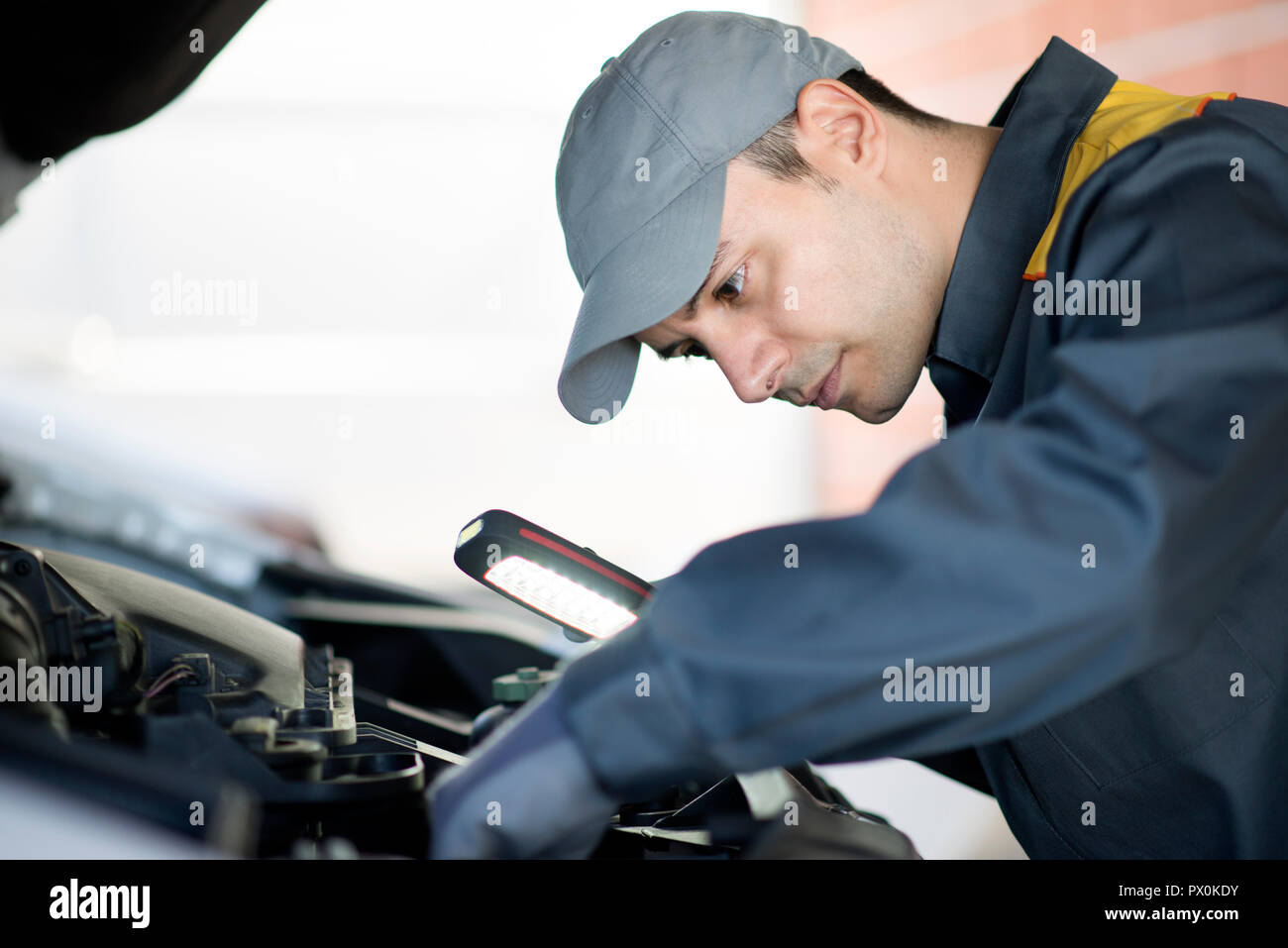 Mechainc fixing a van engine Stock Photo - Alamy