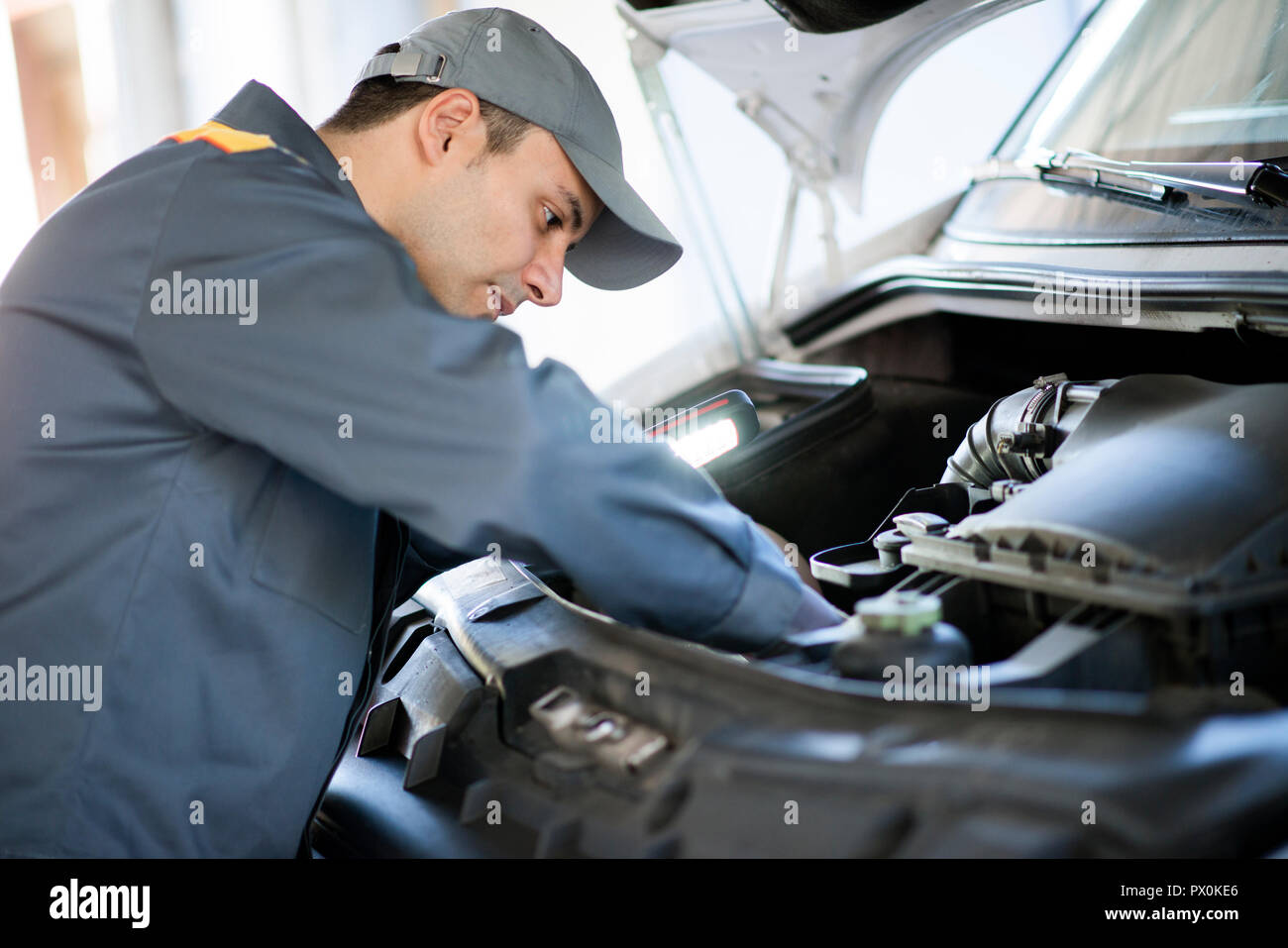 Mechainc fixing a van engine Stock Photo - Alamy
