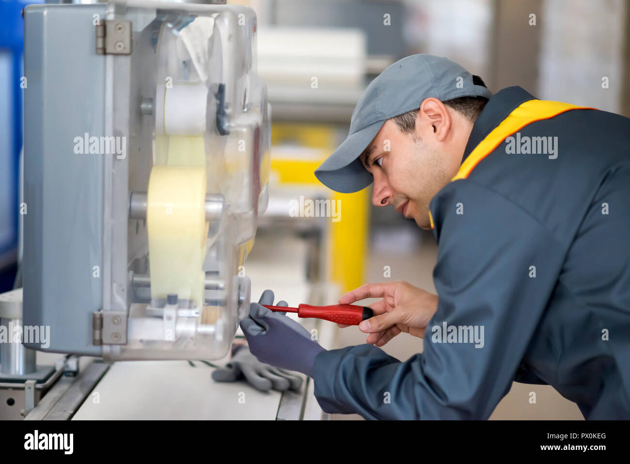 Mechanic fixing a machinery in an industrial environment Stock Photo ...