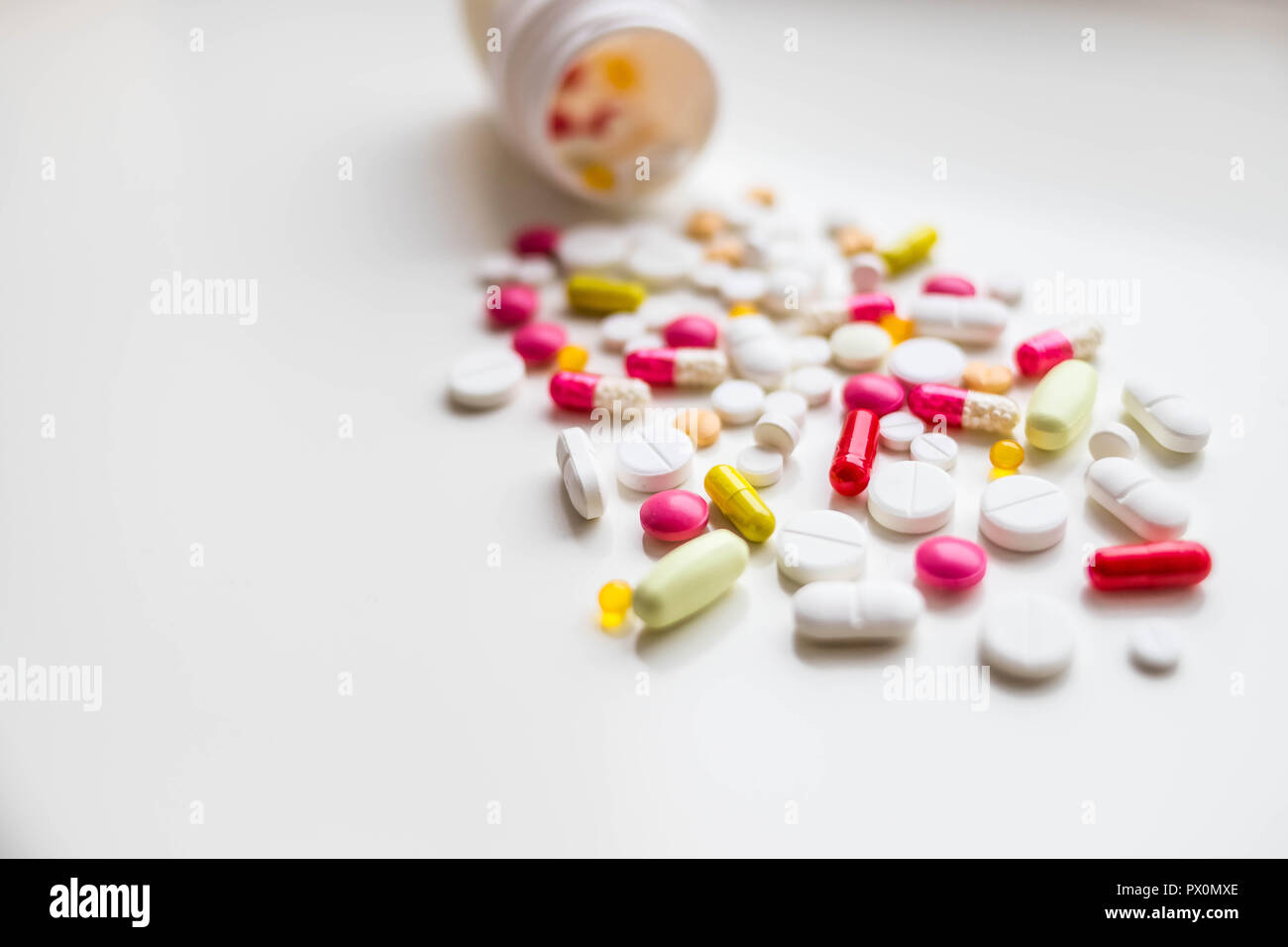 Medicine green and yellow pills or capsules on white background. Drug ...