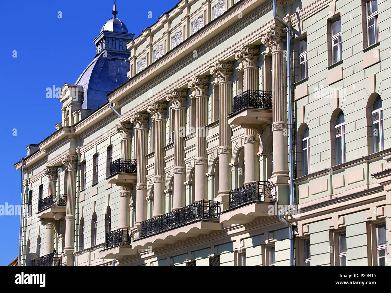 Aged buildings wall with balconies and decorative columns Stock Photo ...