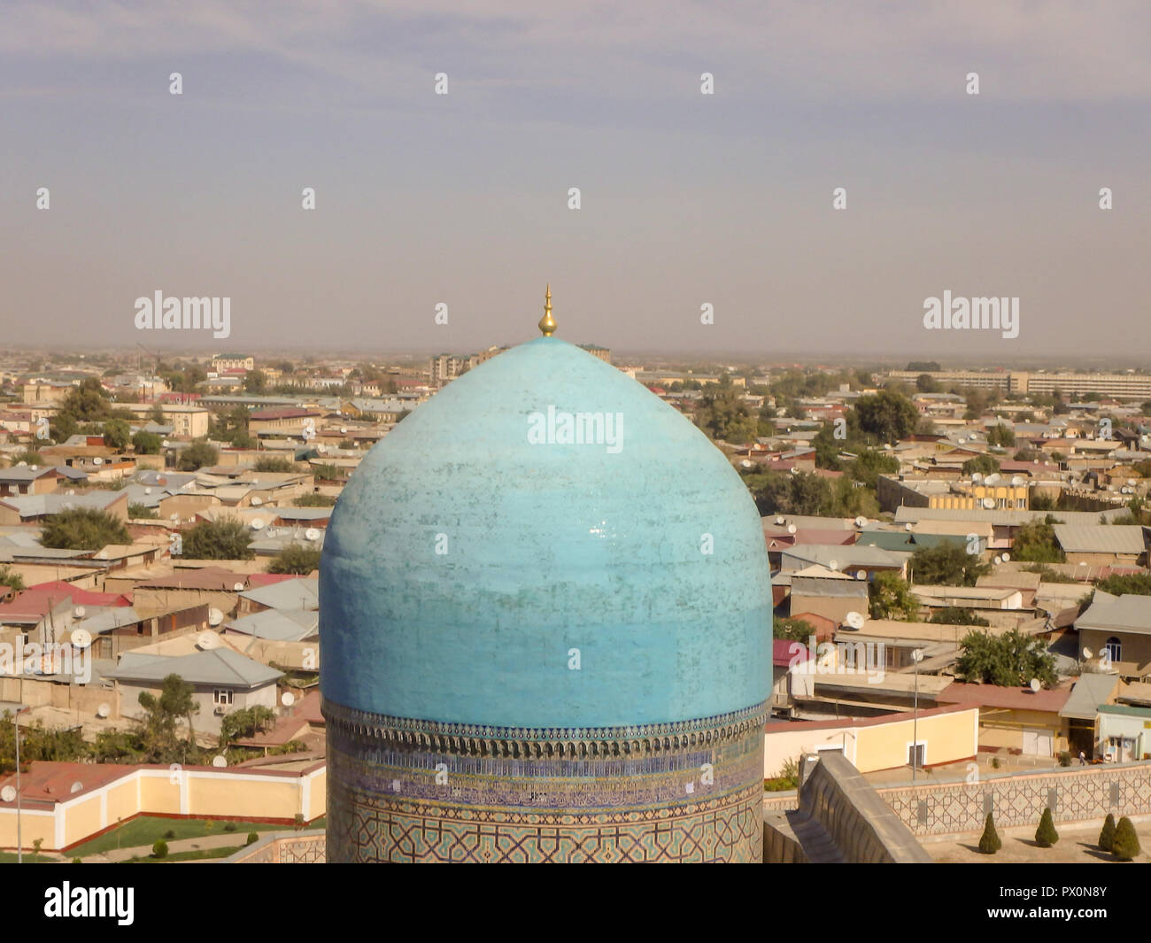 Blue dome on minaret of Registan with skyline in Samarkand, Uzbekistan ...