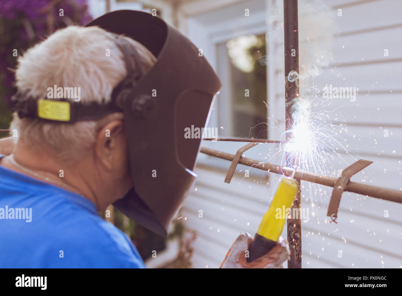 Welder with electric welding mends metallic construction in the country ...