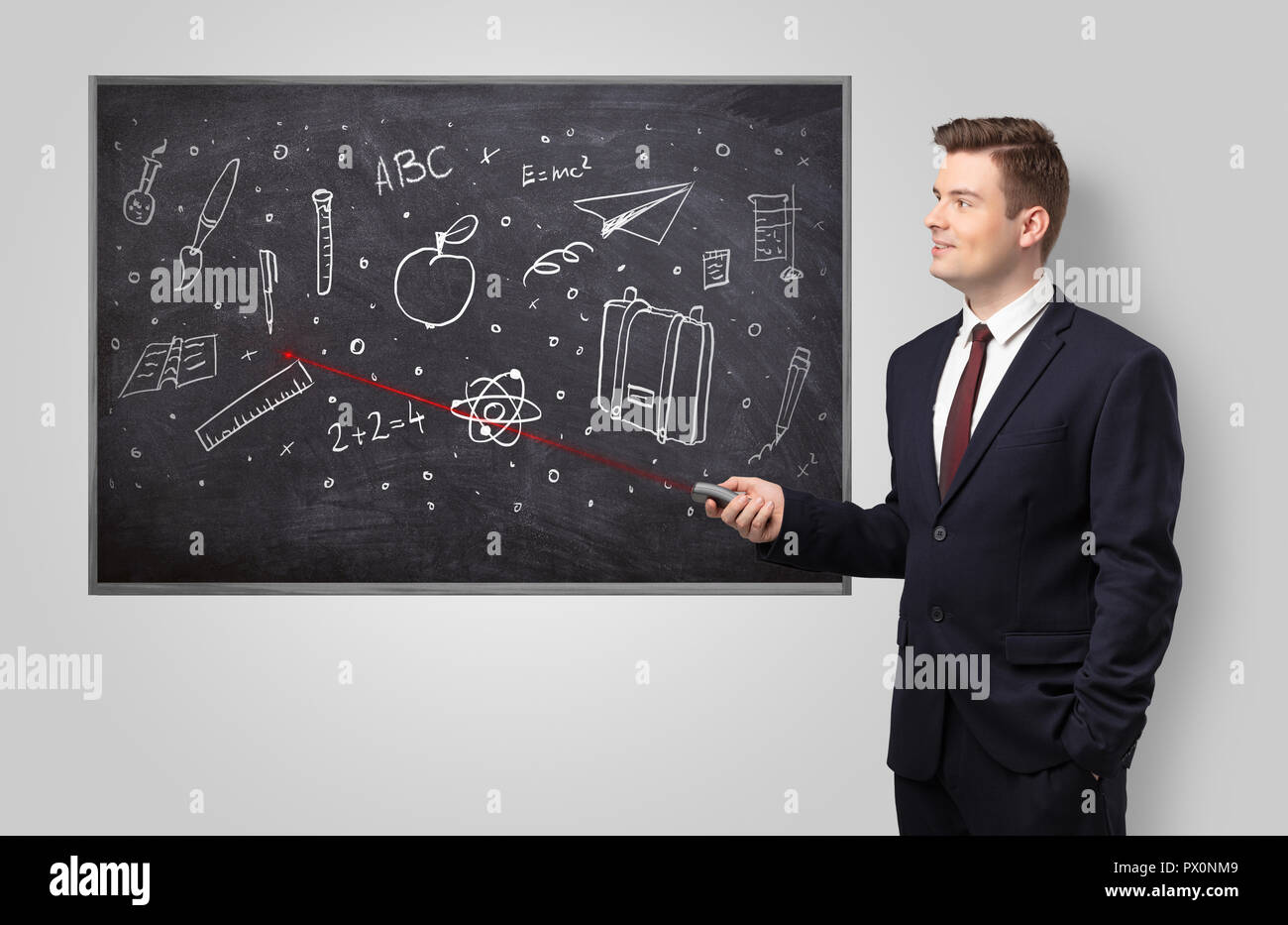 Handsome young teacher with laser pointer teaching Stock Photo - Alamy