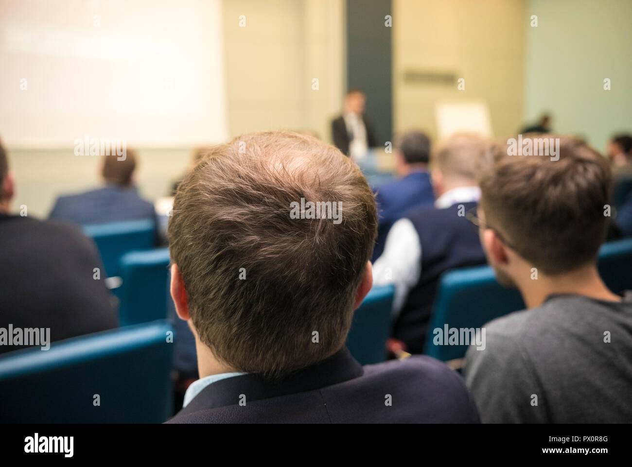 People sitting rear at the business conference. Back view Stock Photo ...