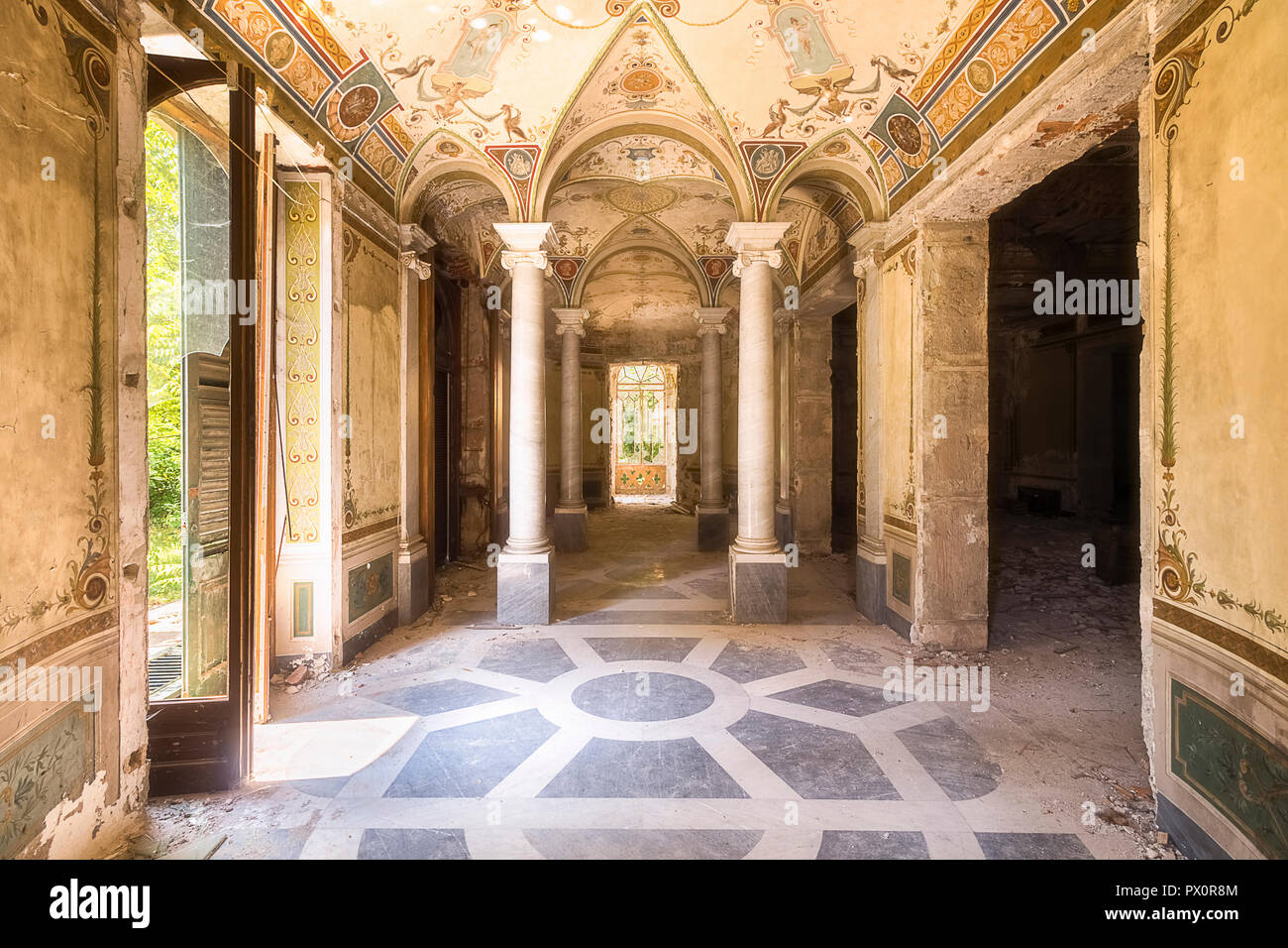 Interior view of an abandoned hallway with pillars in Villa Minetta in ...