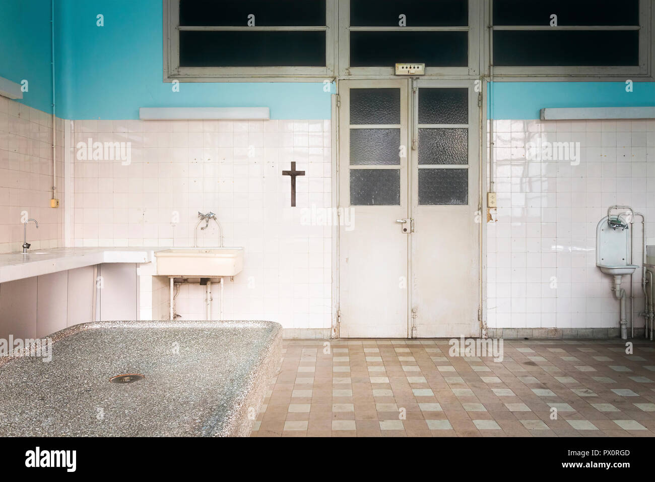 Interior view of room with a table in an abandoned morgue in France ...