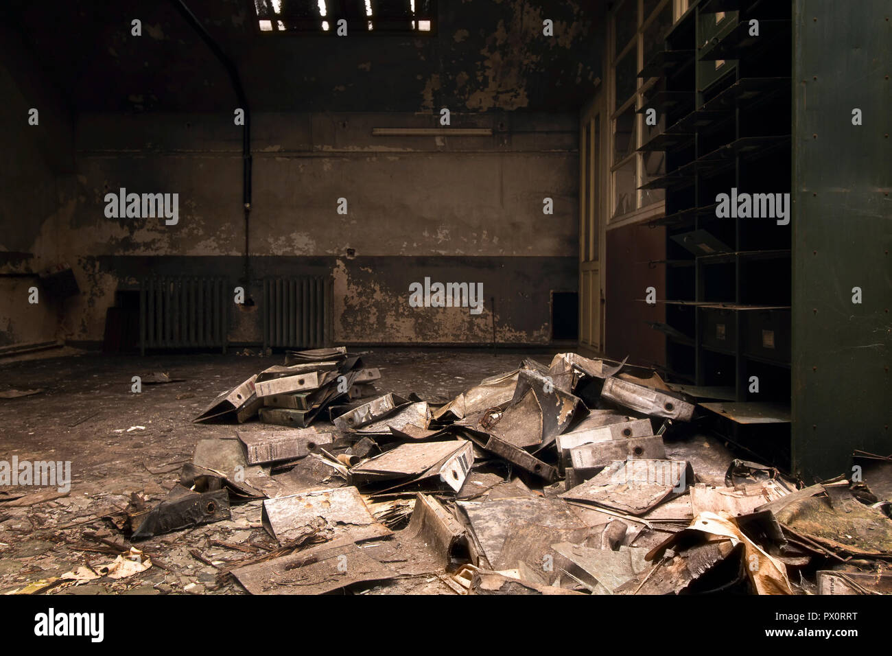 Interior view of a room with books scattered on the floor in an ...