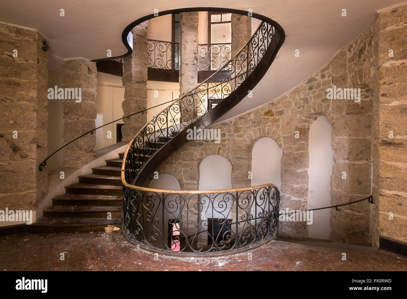Interior view with a spiral staircase in an abandoned castle in France ...