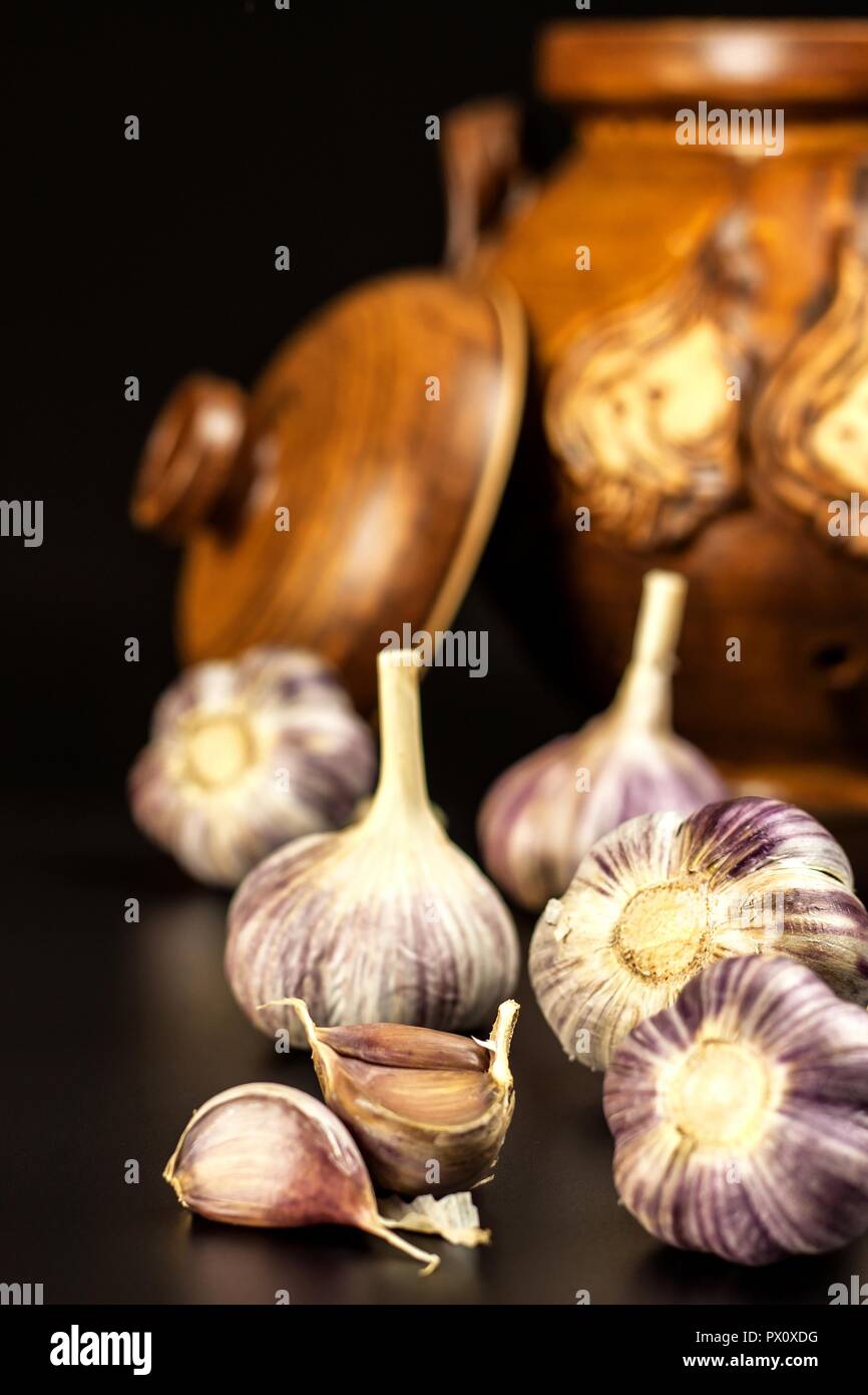 Open garlic on black background table. Whole and split fresh garlic on ...