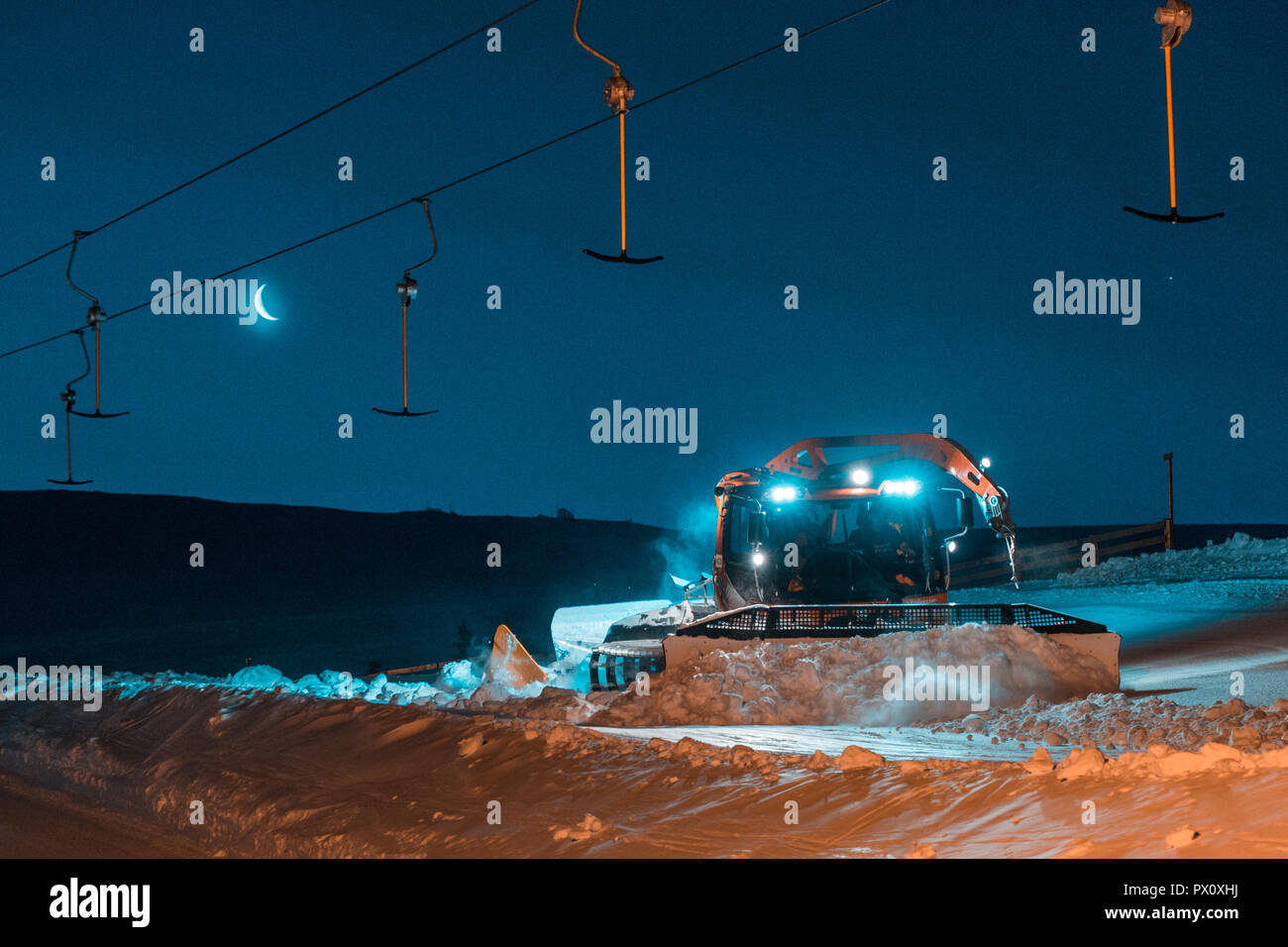 Winter ski holiday in snowy mountains with beautiful glowing red sun ...