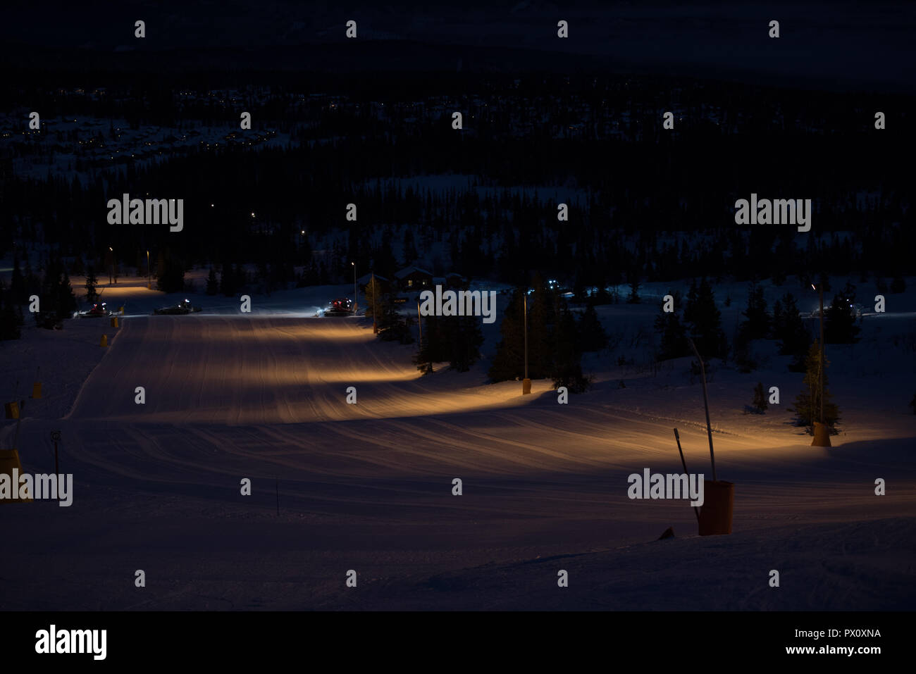 Winter ski holiday in snowy mountains with beautiful glowing red sun ...