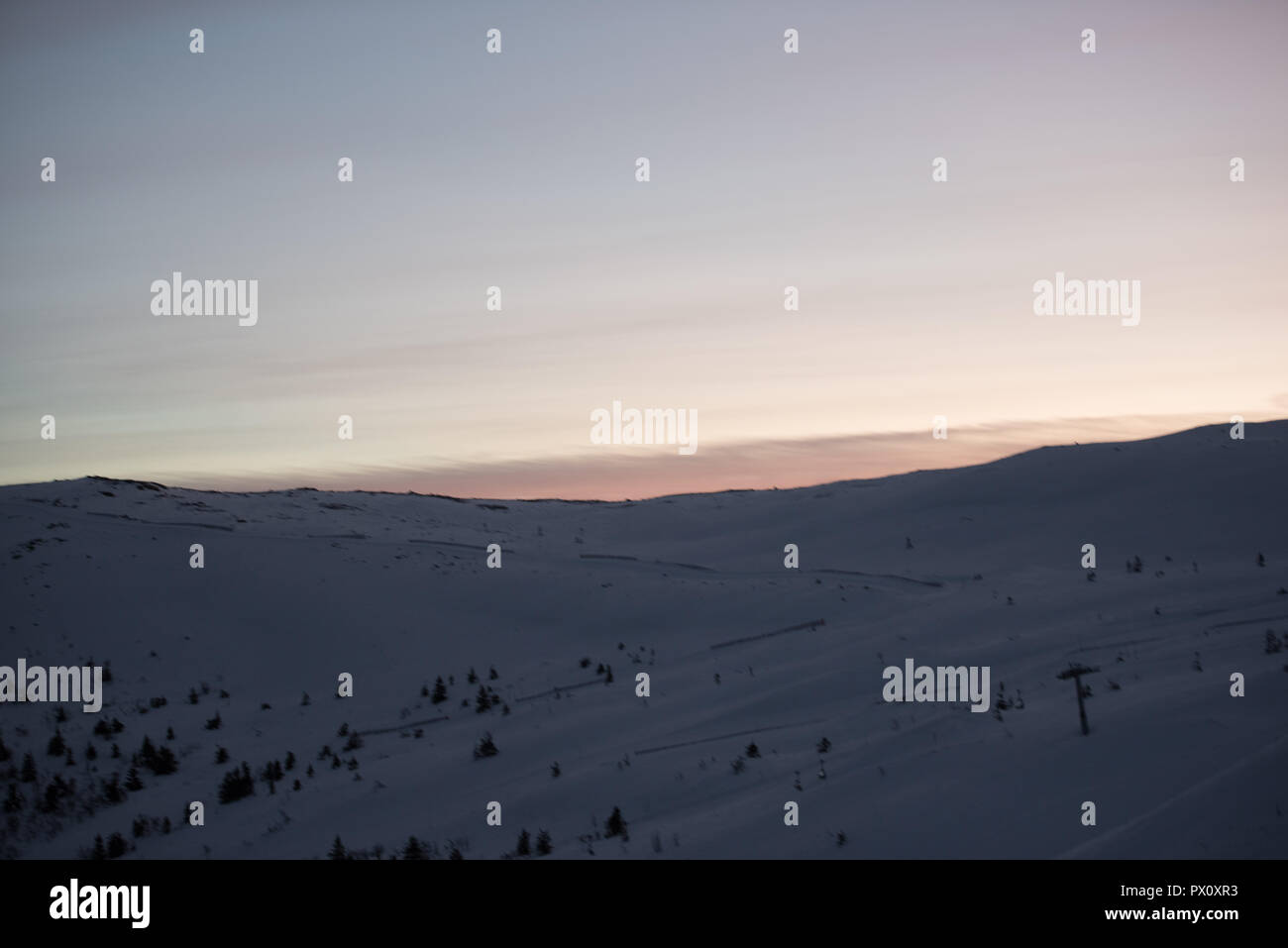 Winter ski holiday in snowy mountains with beautiful glowing red sun ...