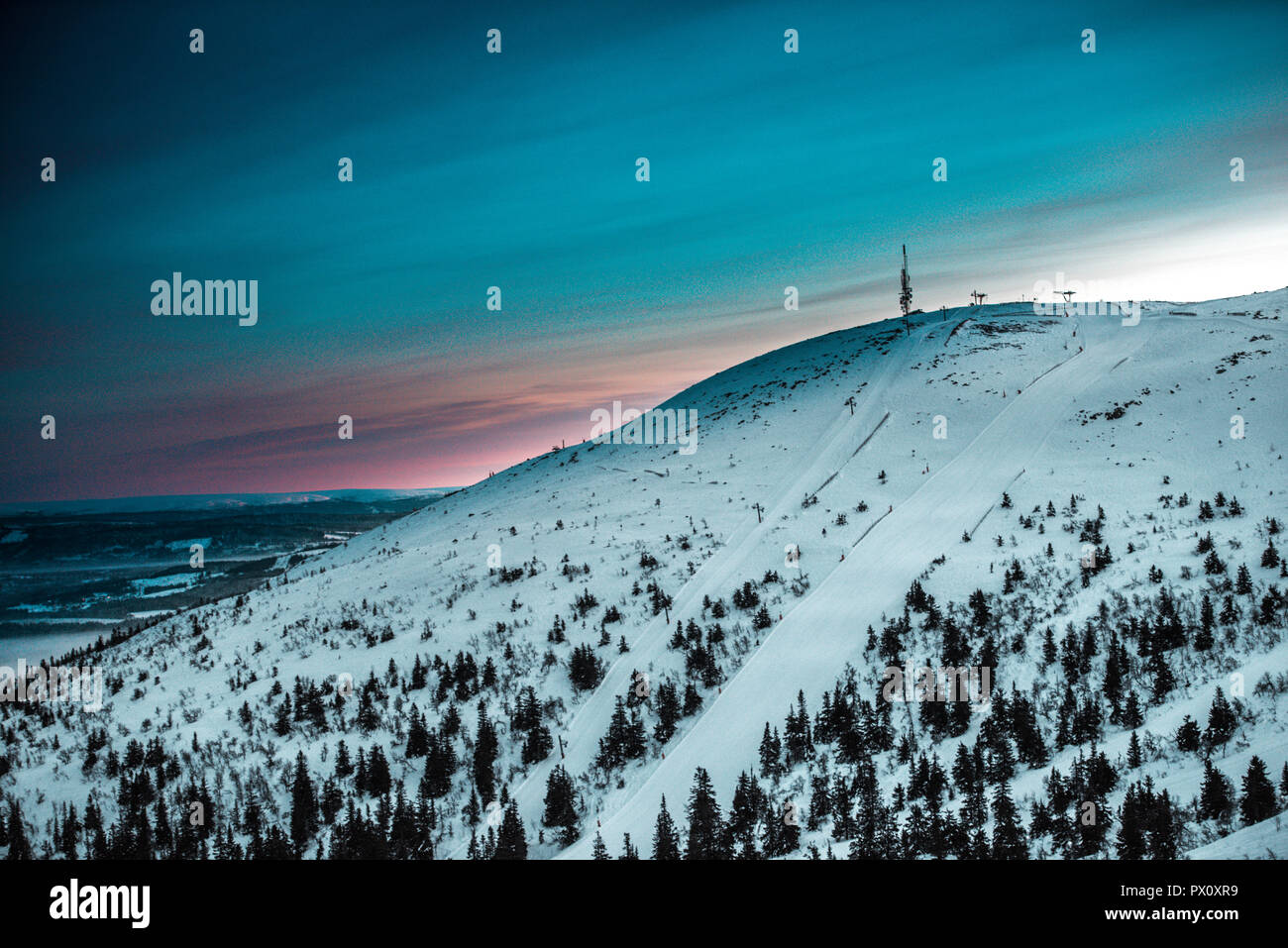 Winter ski holiday in snowy mountains with beautiful glowing red sun ...