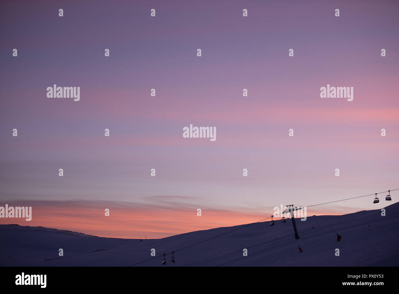Winter ski holiday in snowy mountains with beautiful glowing red sun ...