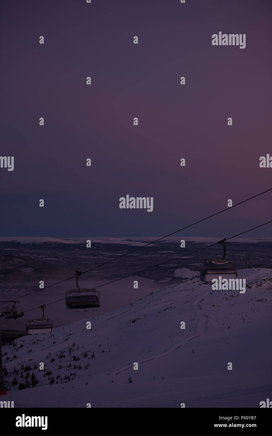 Winter ski holiday in snowy mountains with beautiful glowing red sun ...