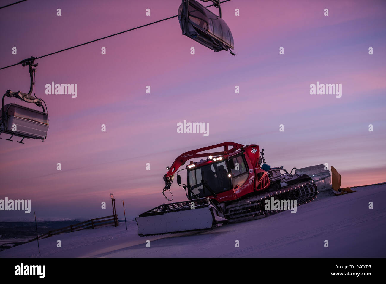 Winter ski holiday in snowy mountains with beautiful glowing red sun ...