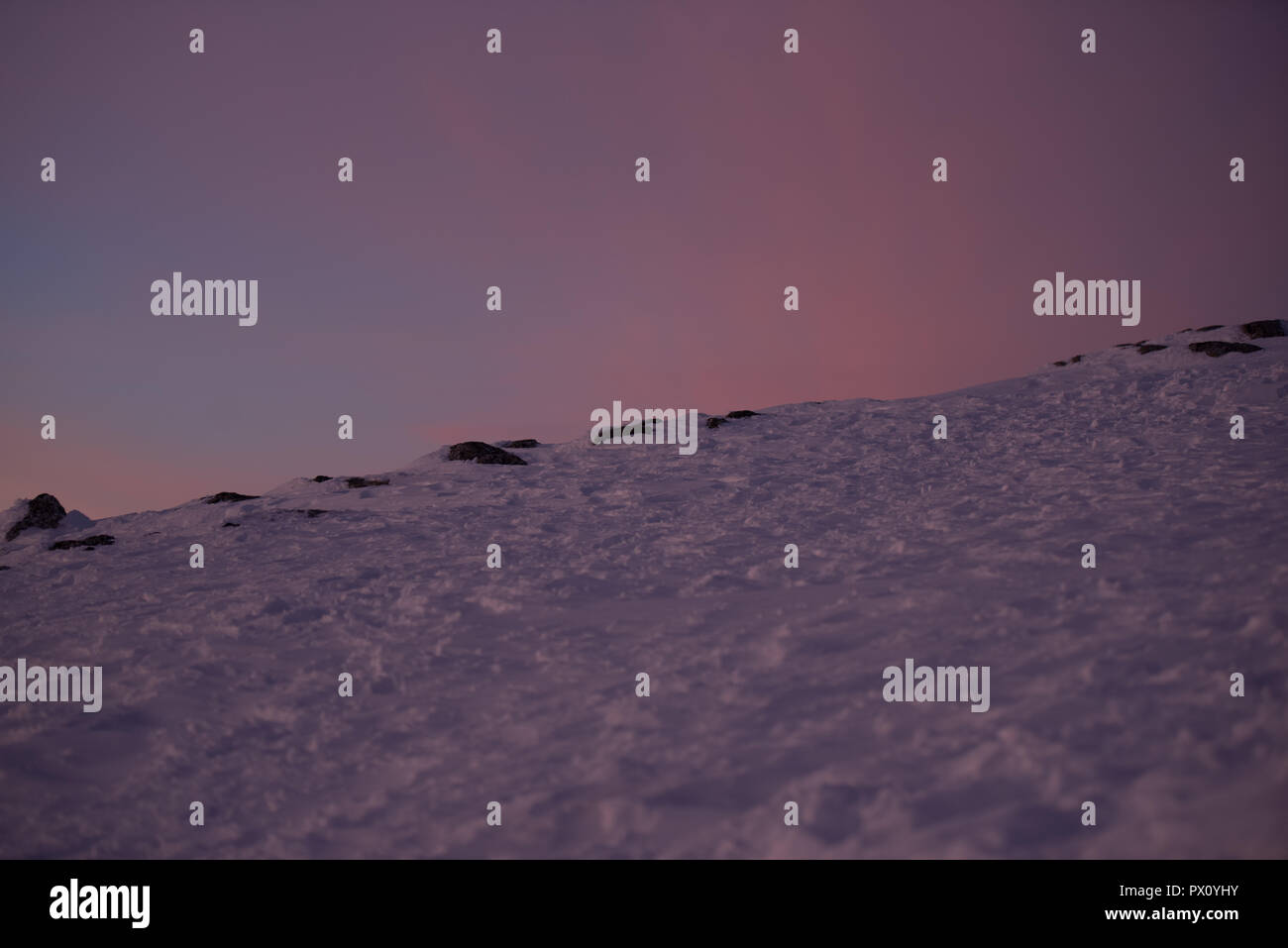 Winter ski holiday in snowy mountains with beautiful glowing red sun ...