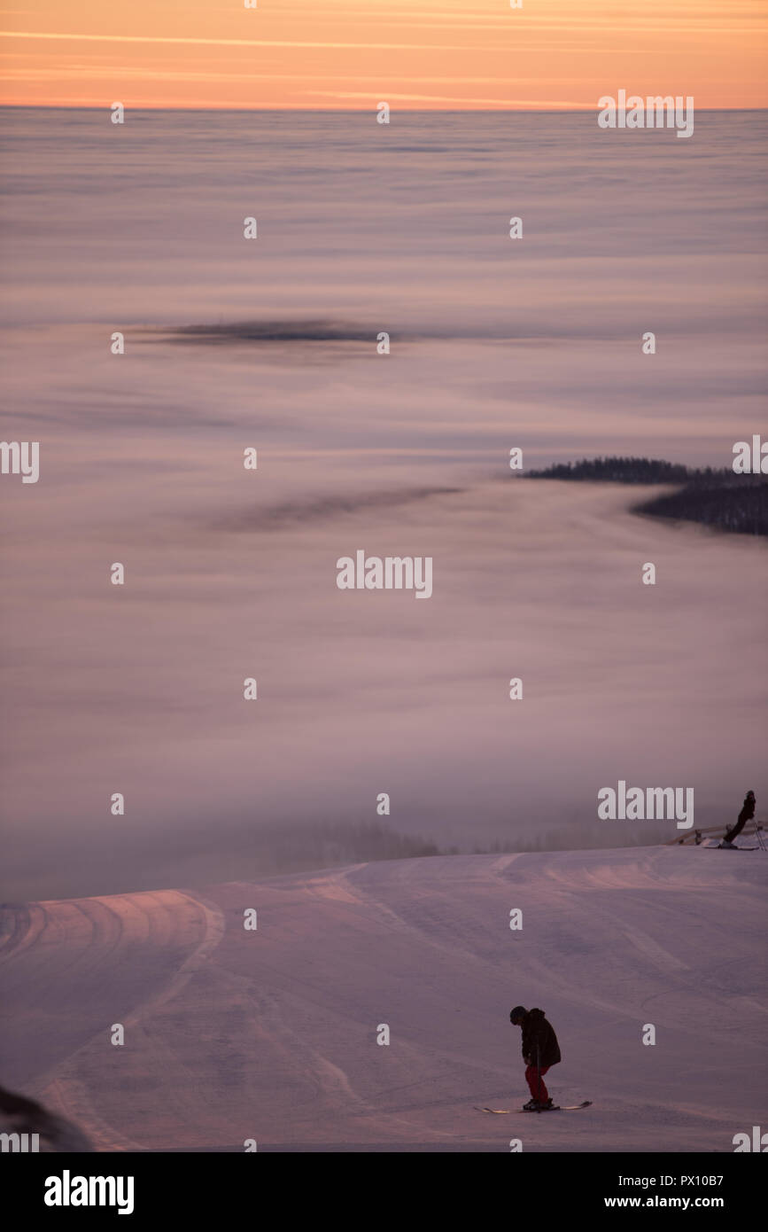 Winter ski holiday in snowy mountains with beautiful glowing red sun ...