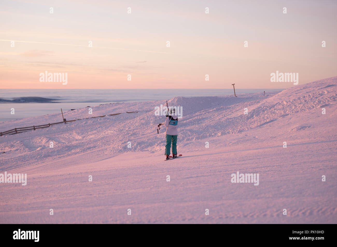 Winter ski holiday in snowy mountains with beautiful glowing red sun ...