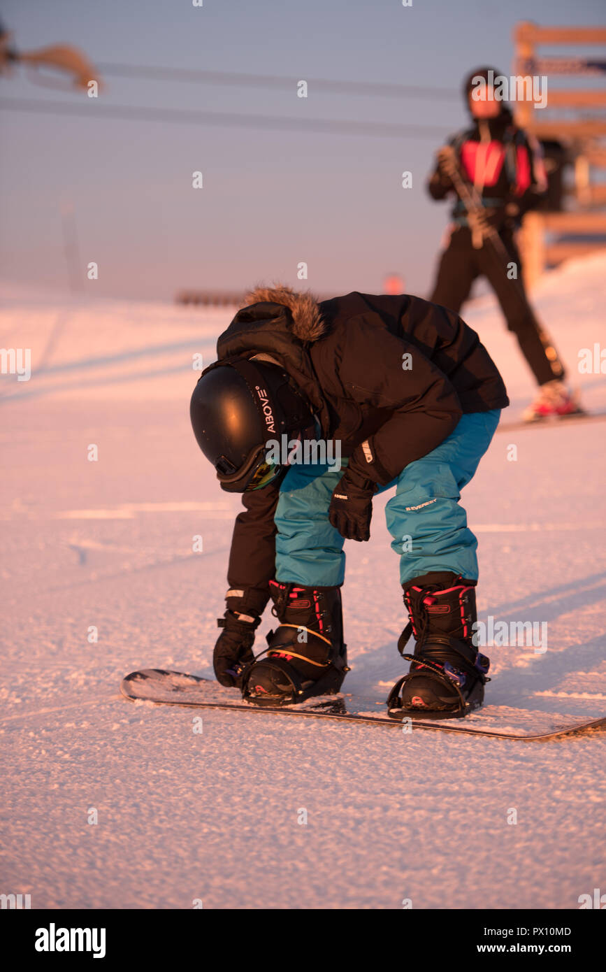 Winter ski holiday in snowy mountains with beautiful glowing red sun ...