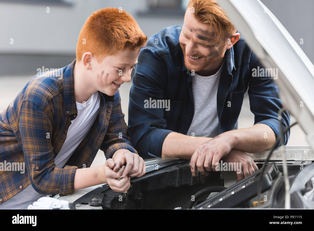 happy father and son repairing car with open hood Stock Photo - Alamy
