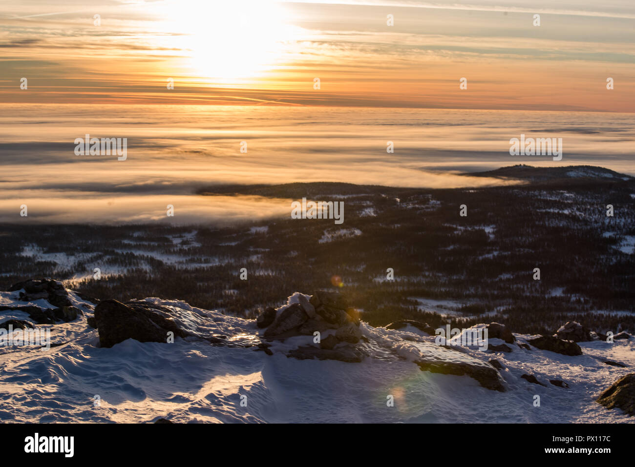 Winter ski holiday in snowy mountains with beautiful glowing red sun ...