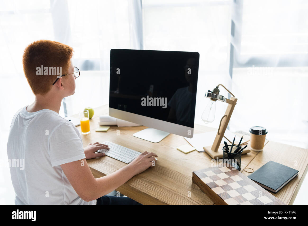 preteen ginger hair boy using computer at home Stock Photo - Alamy