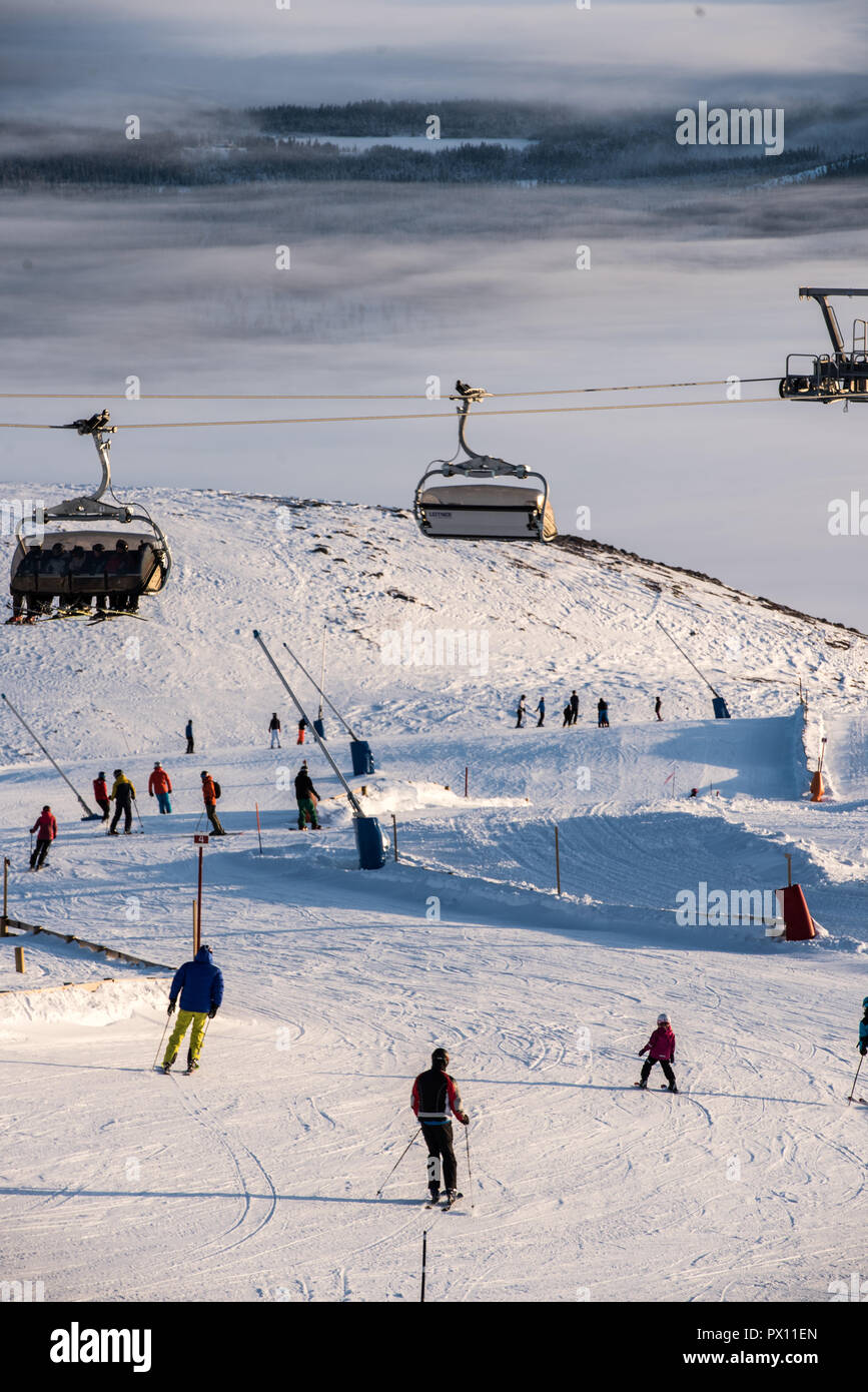 Winter ski holiday in snowy mountains with beautiful glowing red sun ...