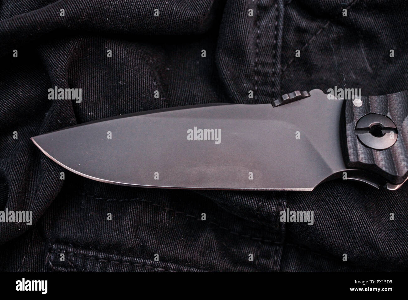 Wide blade knife. Dark Blade. Black knife. Black background of fabric ...