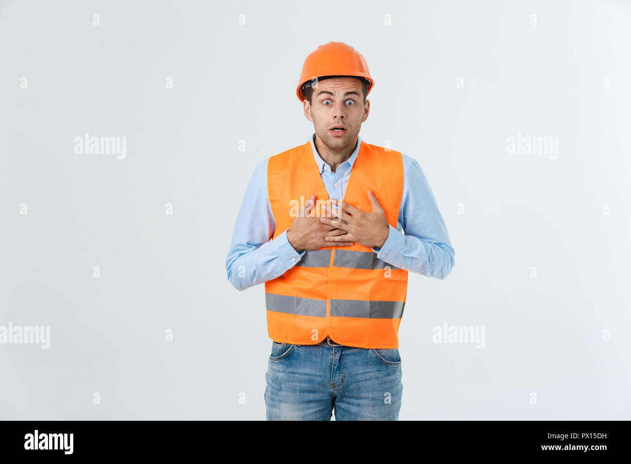 Disappointed handsome engineer wearing orange vest and jeans with ...