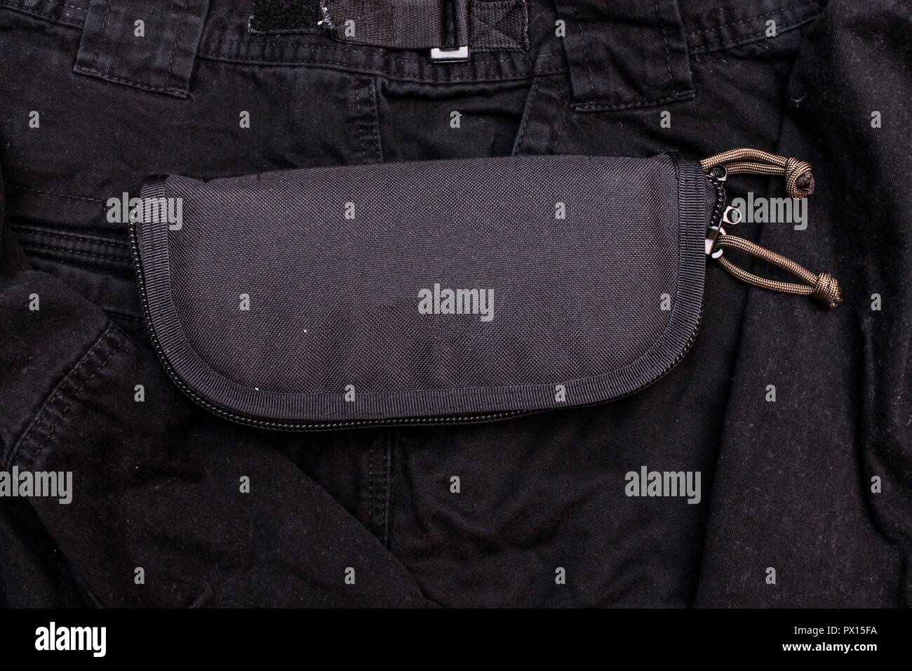 Nylon wallet. Tactical organizer. Black wallet on a black background ...