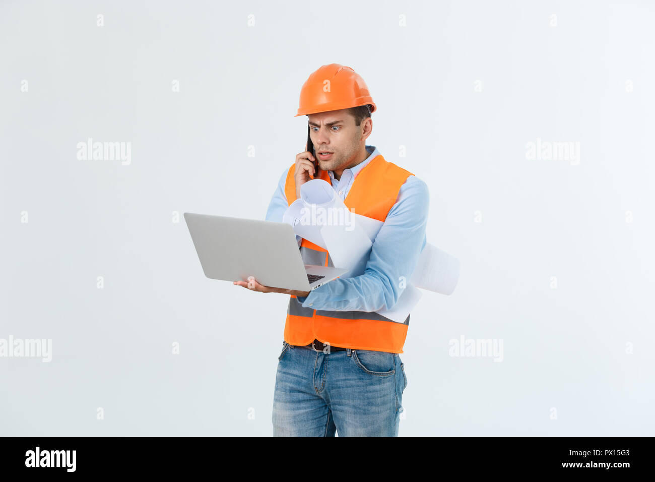 Disappointed handsome engineer wearing orange vest and jeans with ...