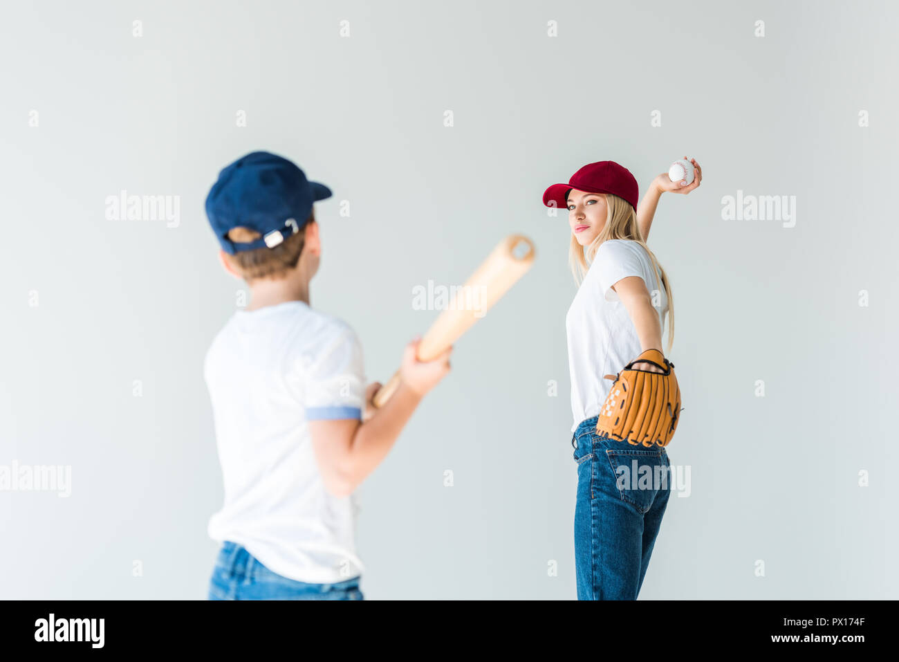 mother and son playing baseball as pitcher and hitter isolated on white ...