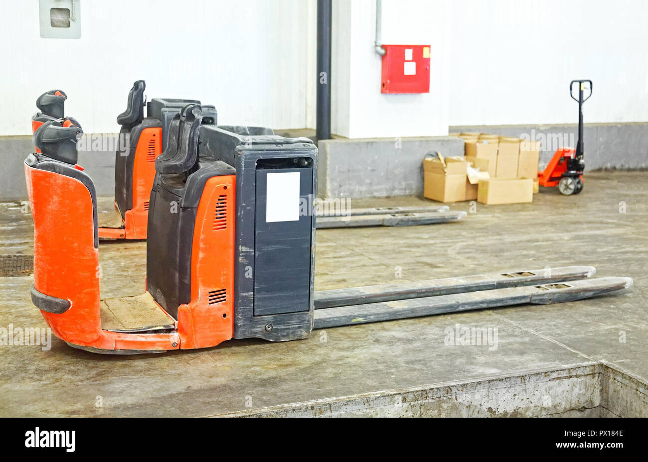 Rider Pallet Truck With Long Fork in Warehouse Stock Photo - Alamy