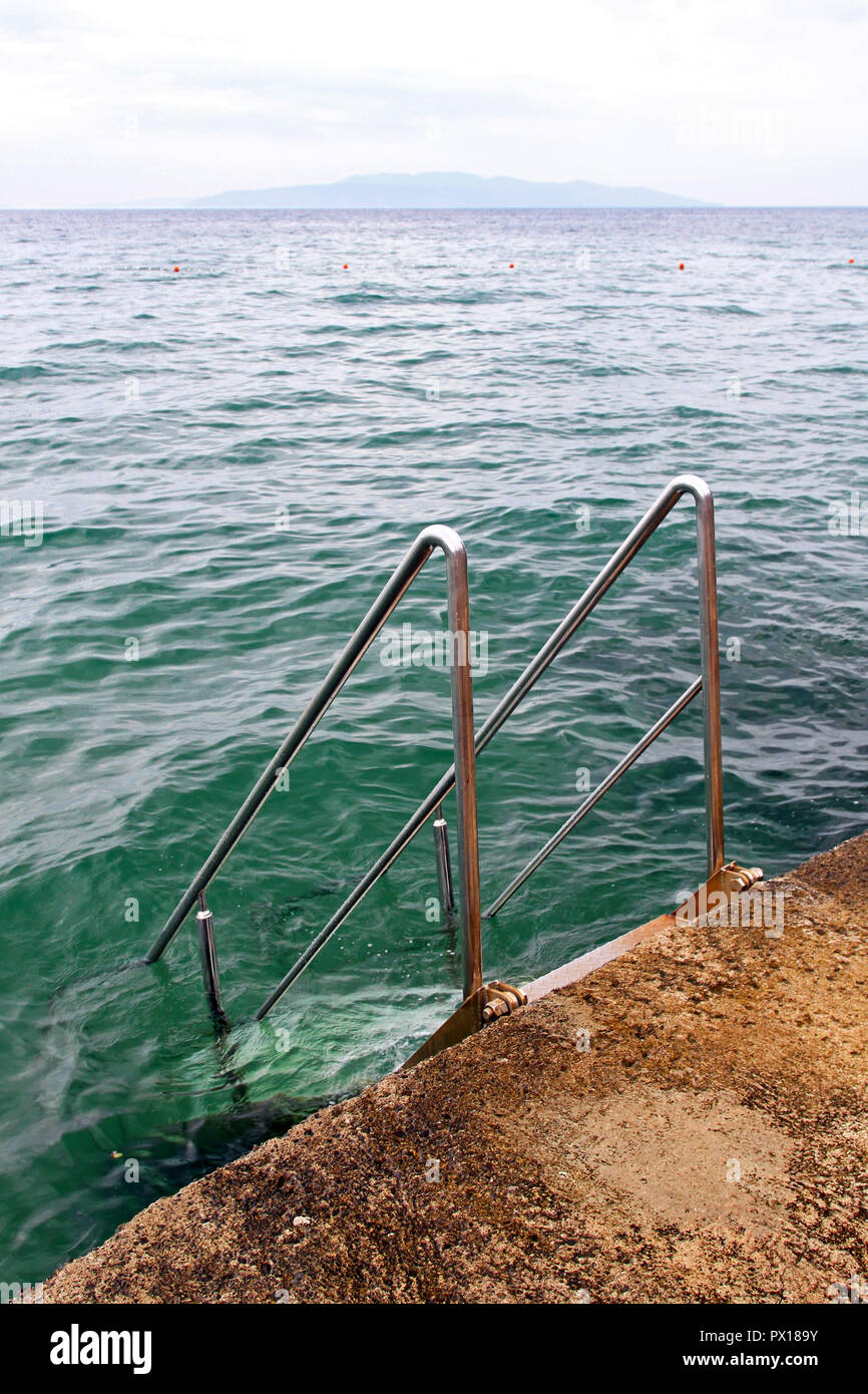 Metal stairway with handrail to the sea Stock Photo - Alamy