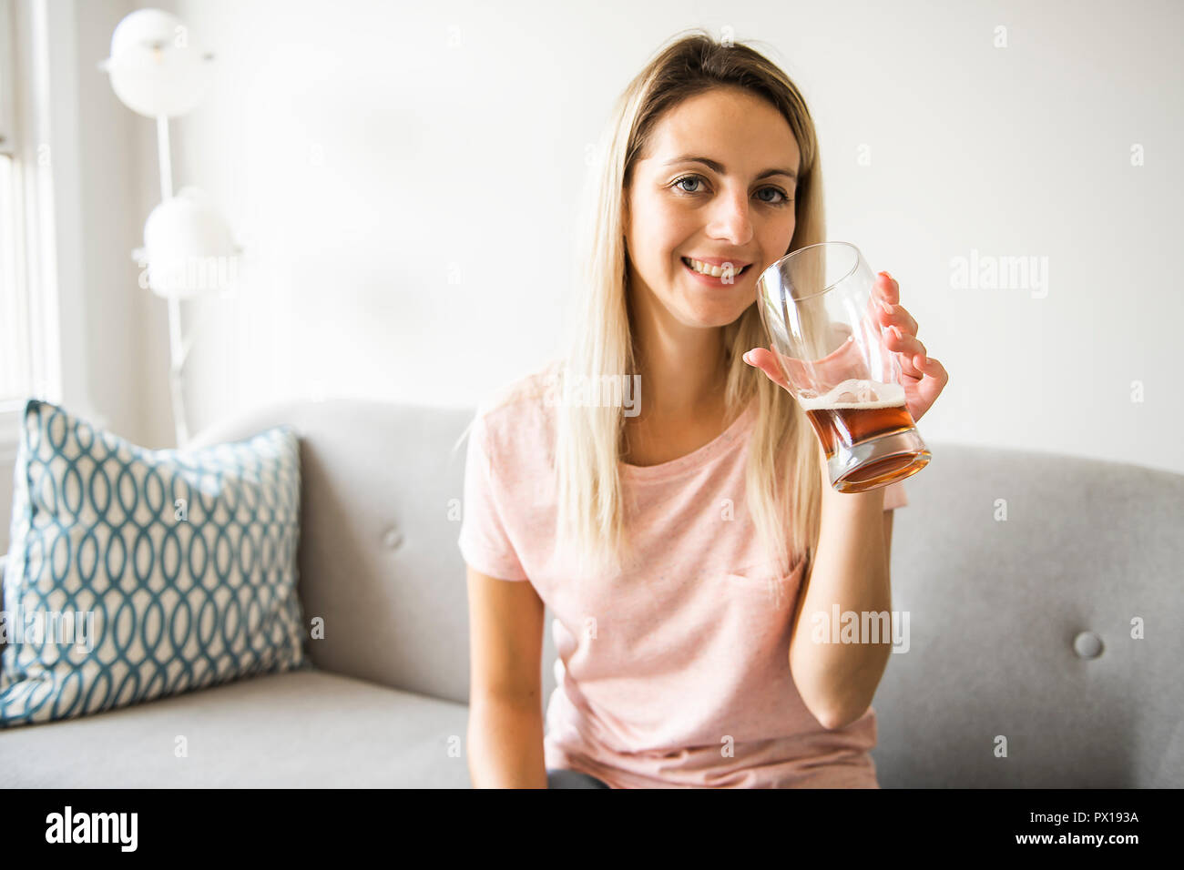 Woman drinking alcohol on sofa hi-res stock photography and images - Alamy