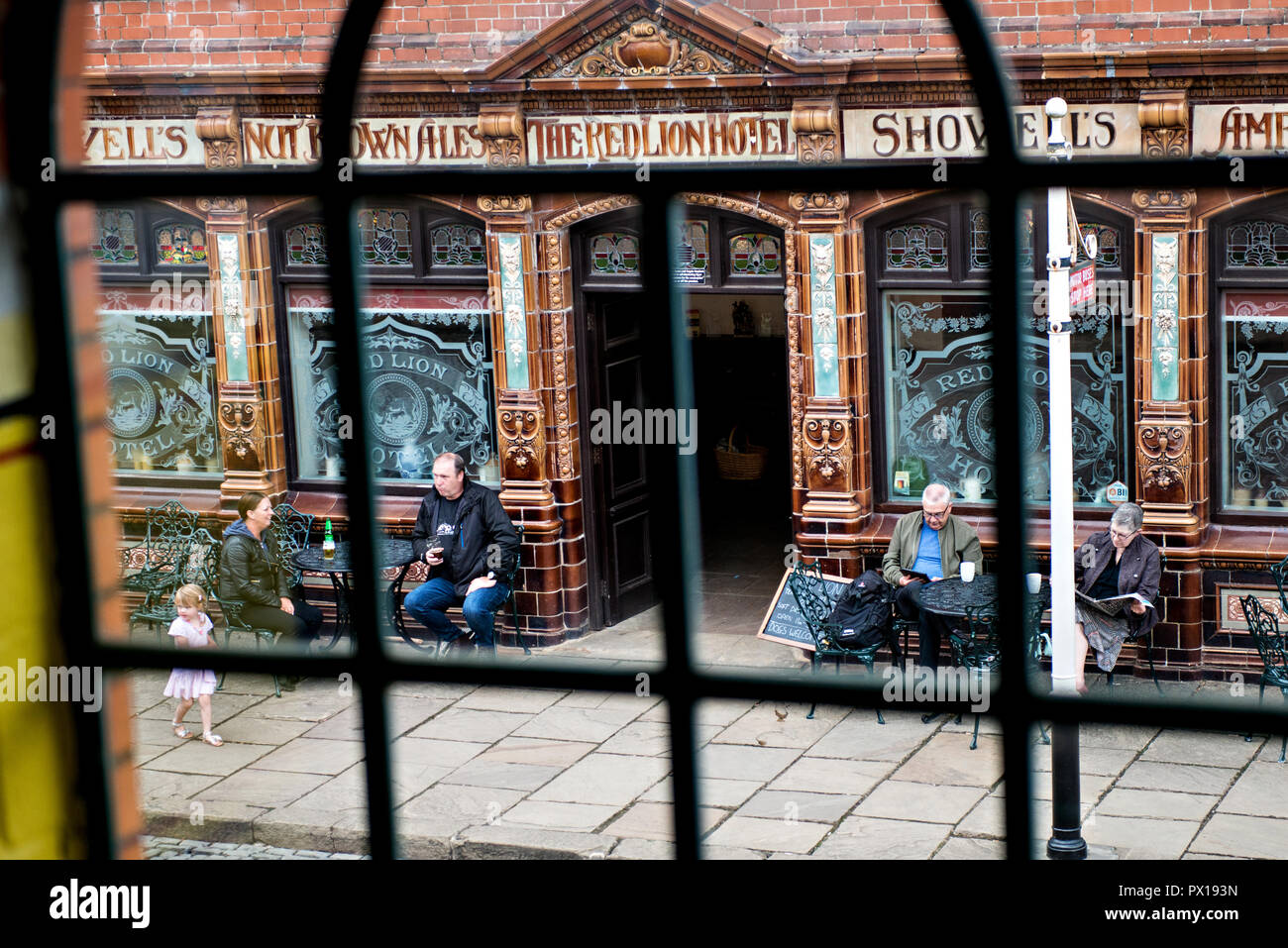 A view through an old arched window of a traditional old English Hotel ...