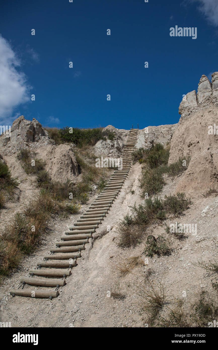 Notch trail ladder leading up to beautiful scenic Lewis on a blue sky ...
