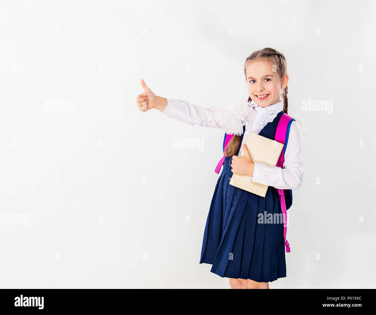 Cute schoolgirl with notebooks and books on a white background ...