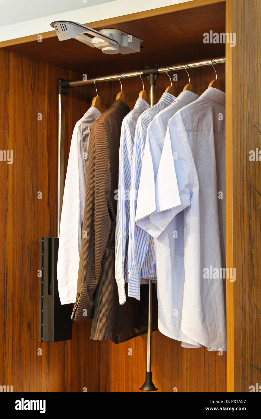 Modern wardrobe closet with shirts and suit Stock Photo - Alamy