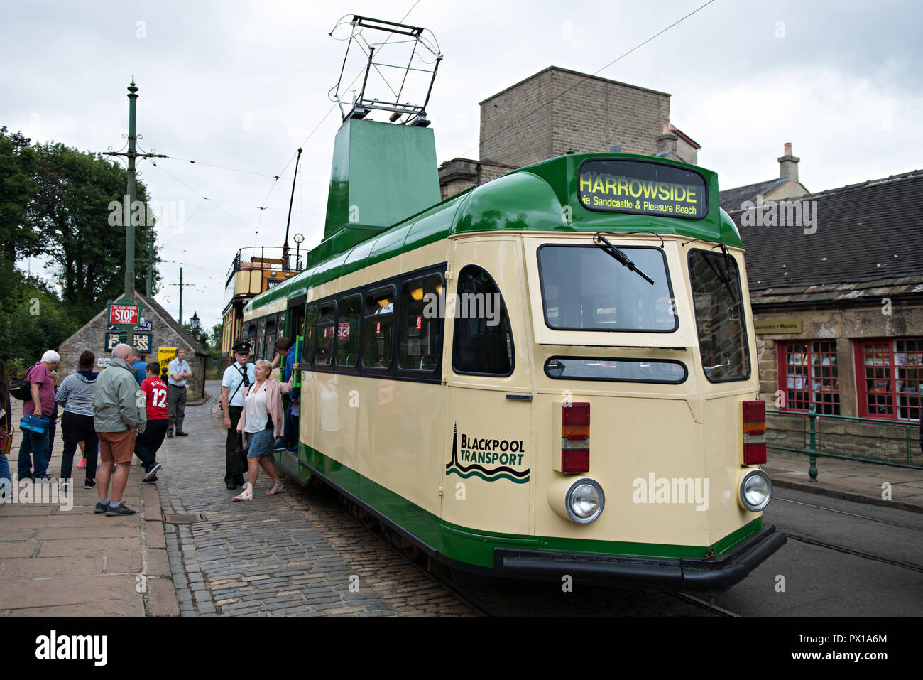 Passengers stepping out of an old vintage Blackpool tram at Crich ...