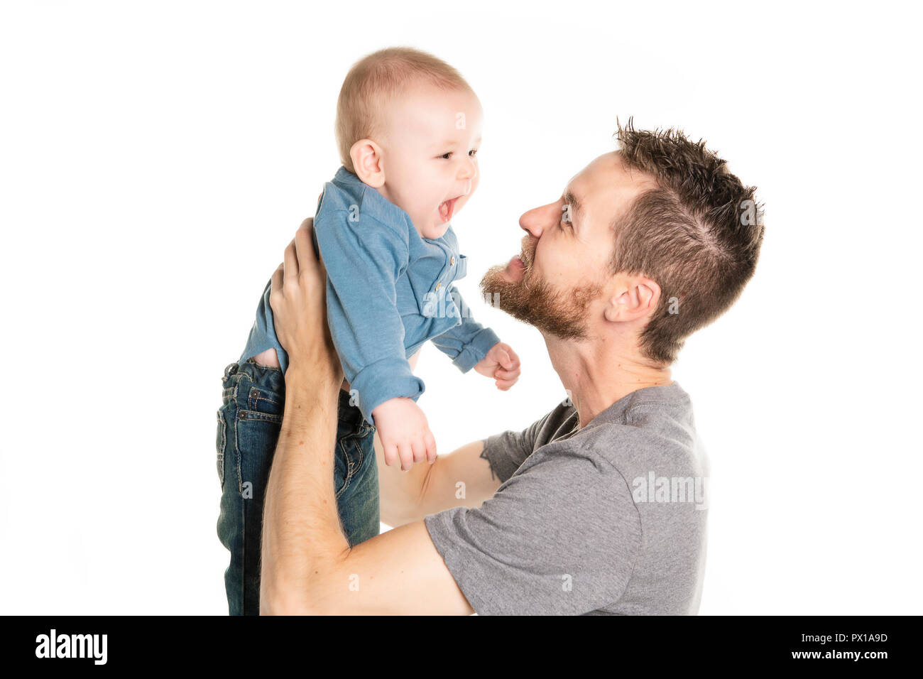 Father with cute baby on studio white background Stock Photo - Alamy
