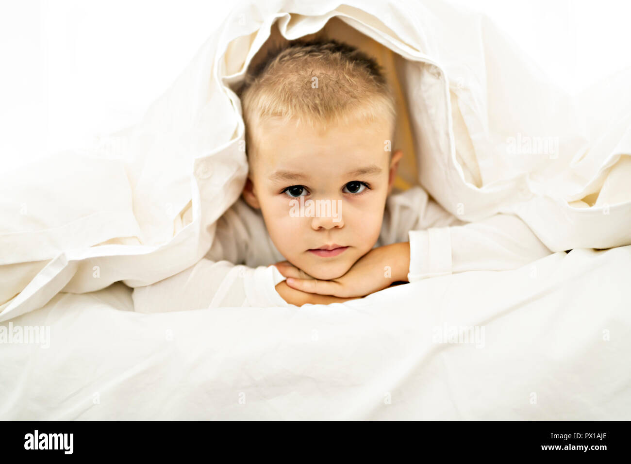 cute four years boy in white bedding Stock Photo - Alamy