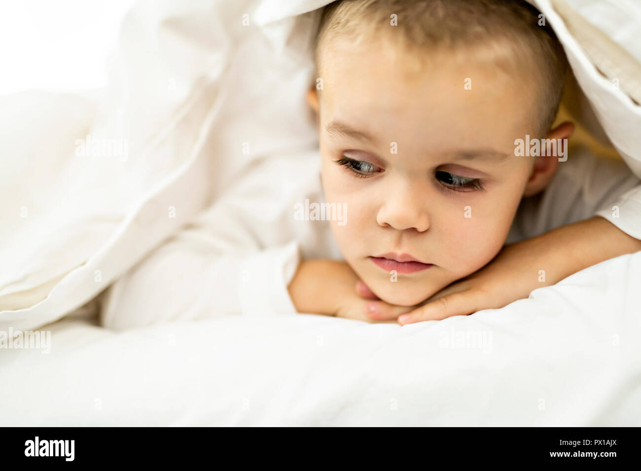 cute four years boy in white bedding Stock Photo - Alamy