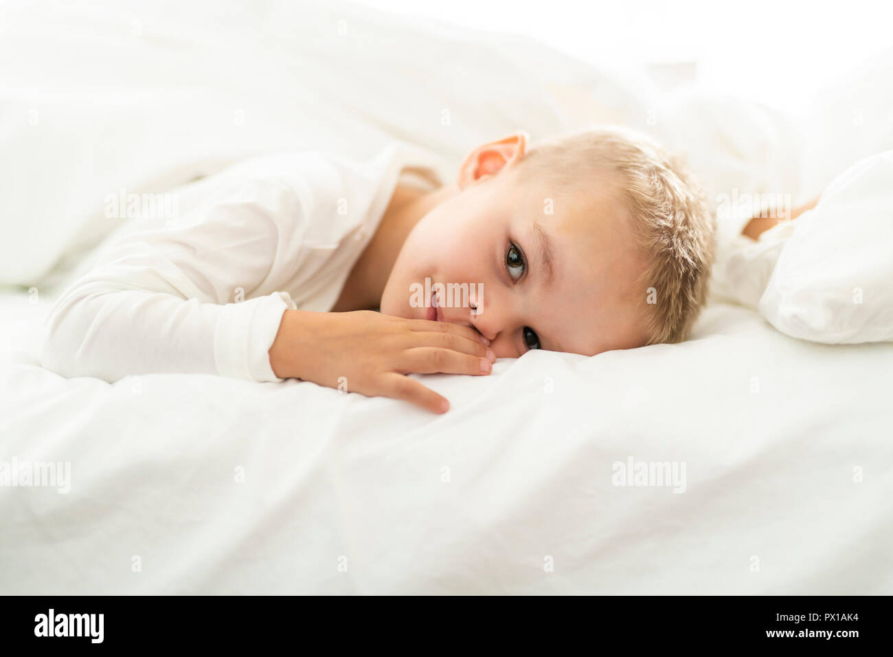 cute four years boy in white bedding Stock Photo - Alamy