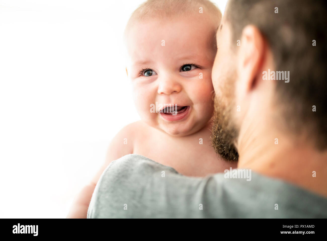 family father with baby boy in front of window Stock Photo - Alamy