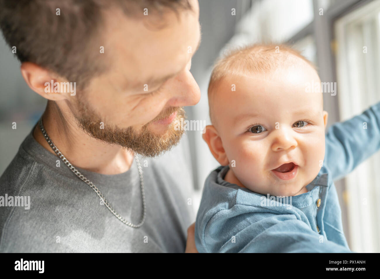 Father carrying child in arms hi-res stock photography and images - Alamy