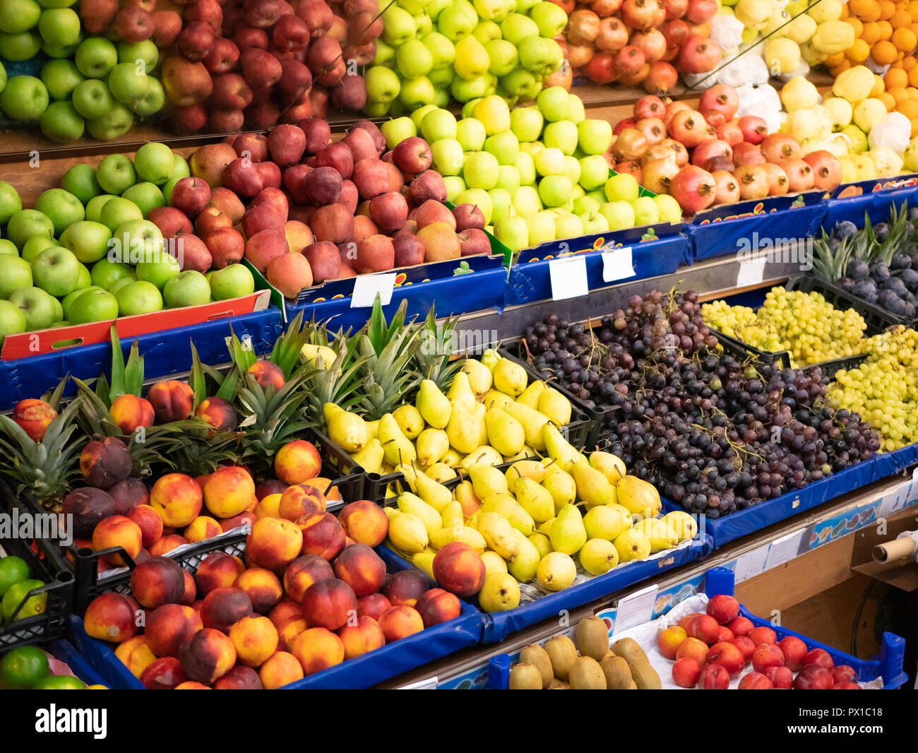 organic fruit counters at green food store market. side high angle shot ...