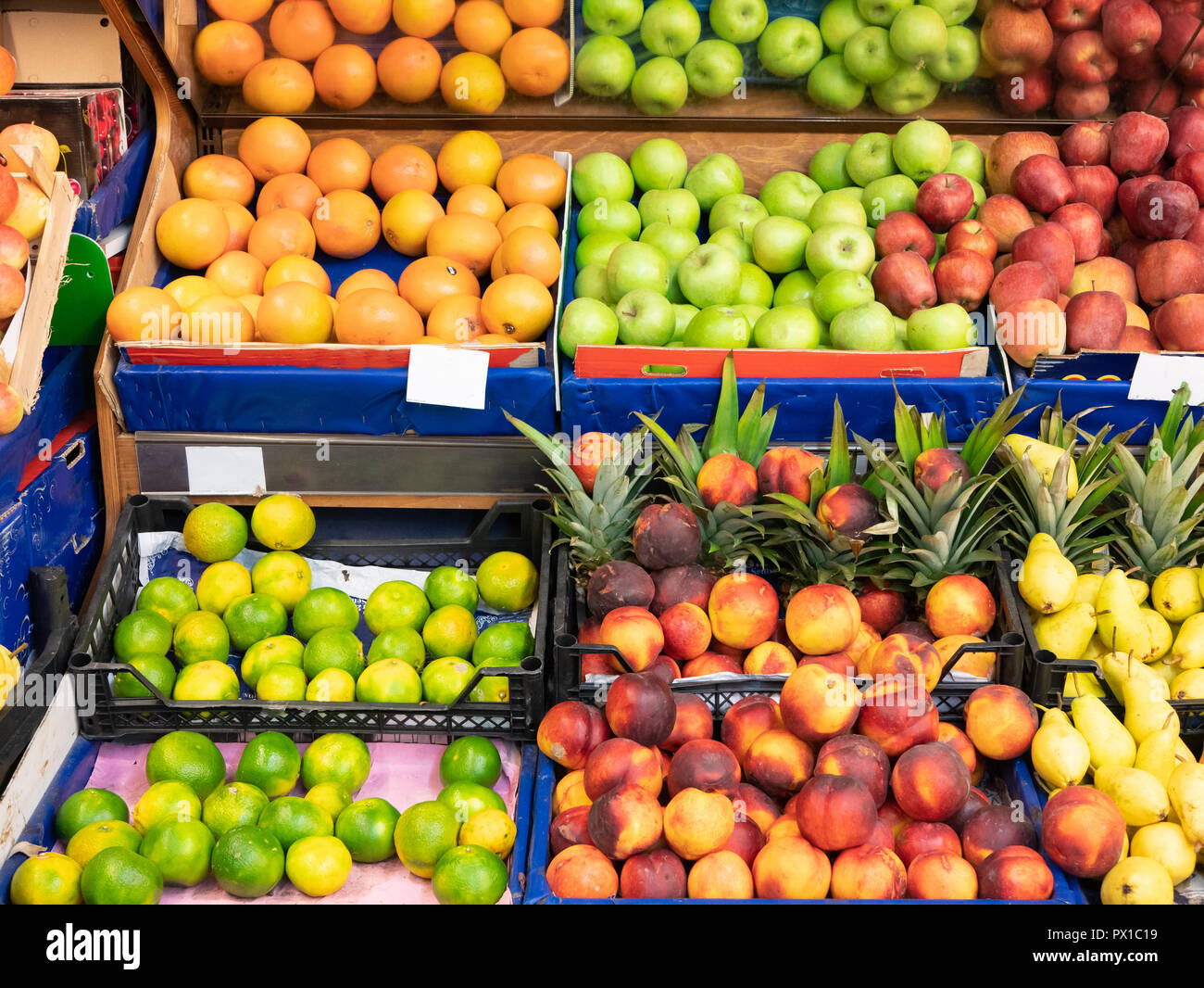 fruit counters in super market shopping mall - apples, peaches, oranges ...